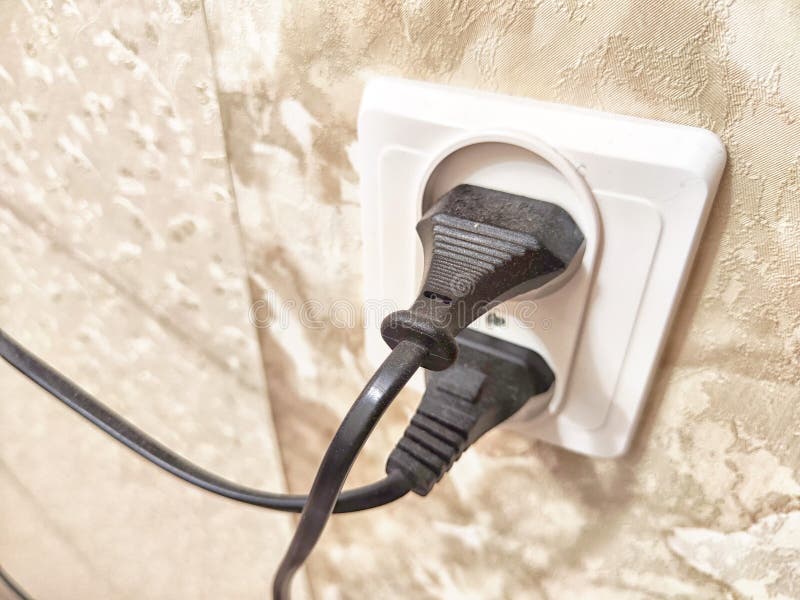 Cables Connected To Power Sockets Against a Decorative Wall. Dual ...