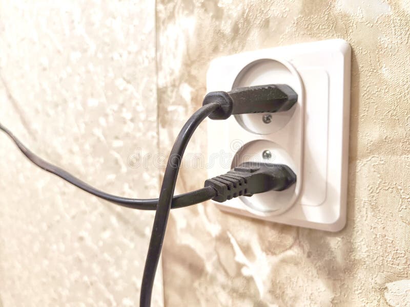 Cables Connected To Power Sockets Against a Decorative Wall. Dual ...