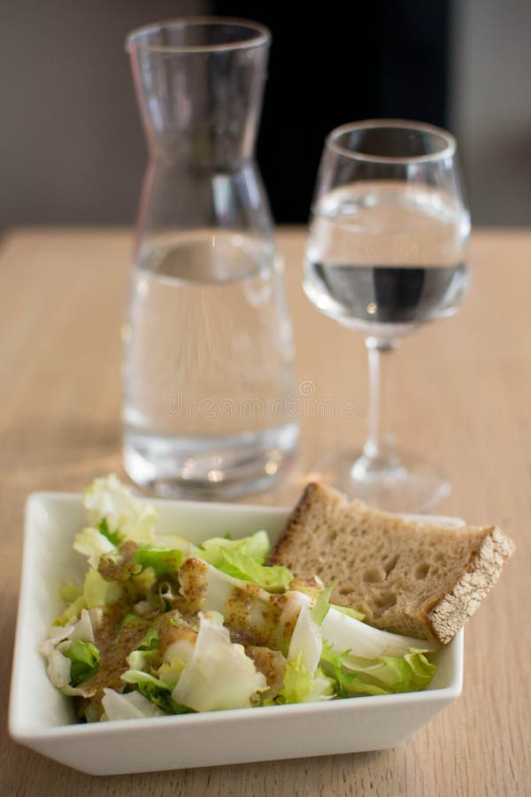Caesar Salad, Artisanal Bread and Glass of Water in Paris Stock Photo ...