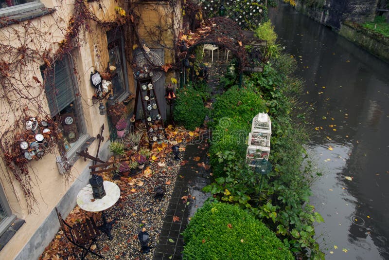 Cafe with a Lot of Clocks and Canal in Bruges, Belgium Stock Photo ...