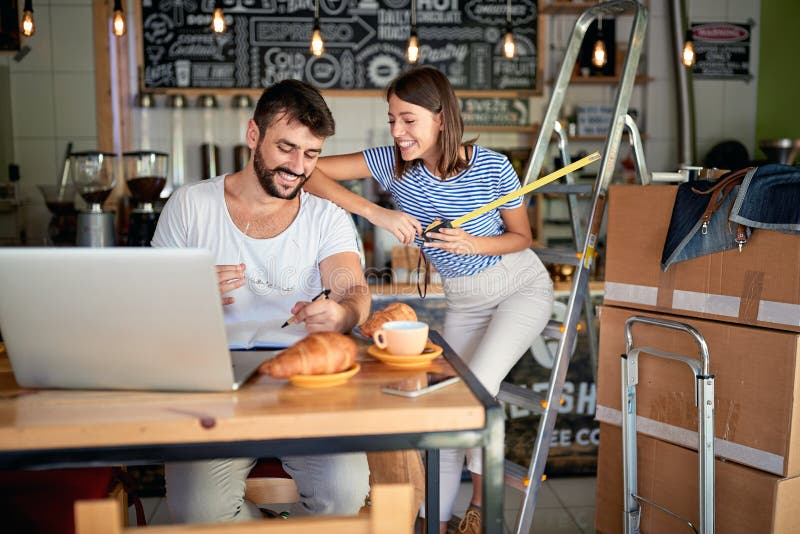 Cafe Managers Working on Laptop Ready To Open Their Cafe Stock Photo ...