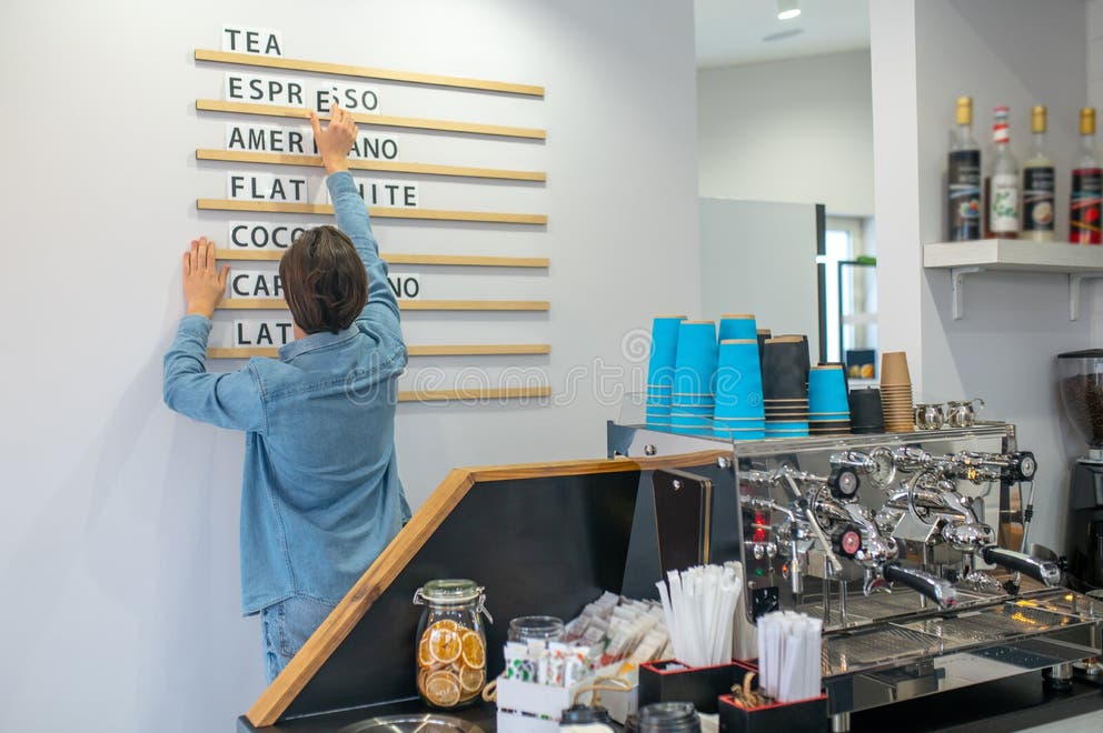 A Cafe Owner Changing Menu and Lookin Involved Stock Photo - Image of ...