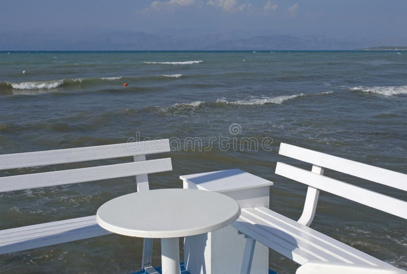 Seafront with Table and Bench Stock Photo - Image of vacation, white ...