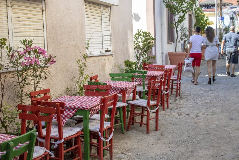 Cafe Tables and Chairs in the Street. People Walking on the Street ...