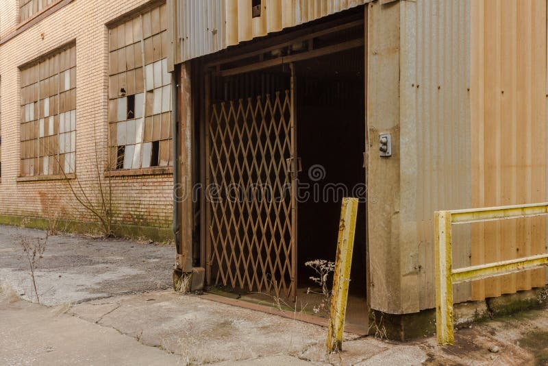 Cage Door Left Open on the Side of an Abandoned Factory Stock Photo ...