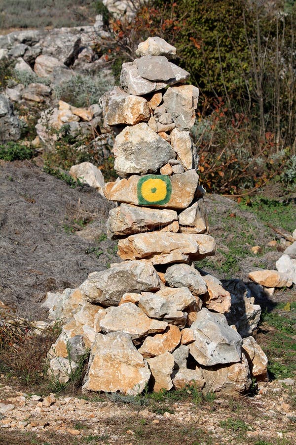Cairn of Stacked Rocks with Yellow Trail Marker Stock Photo - Image of ...