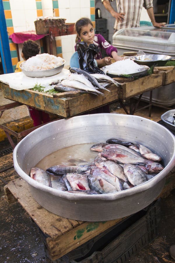 CAIRO, EGYPT - DECEMBER 29, 2021: Seller at the Central Fish Market in ...