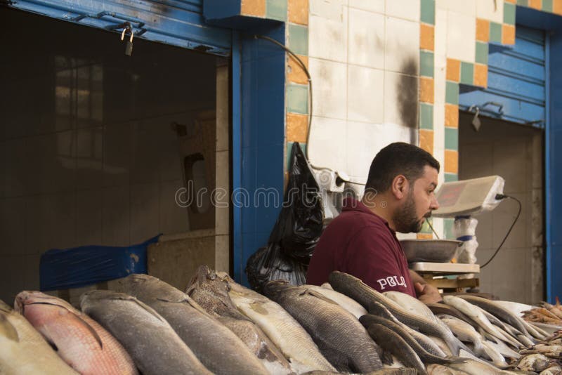 CAIRO, EGYPT - DECEMBER 29, 2021: Seller at the Central Fish Market in ...