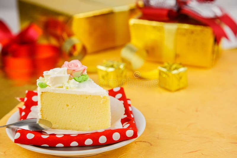 Cake on Dish Against Golden Gift Boxes Stock Image - Image of piece ...