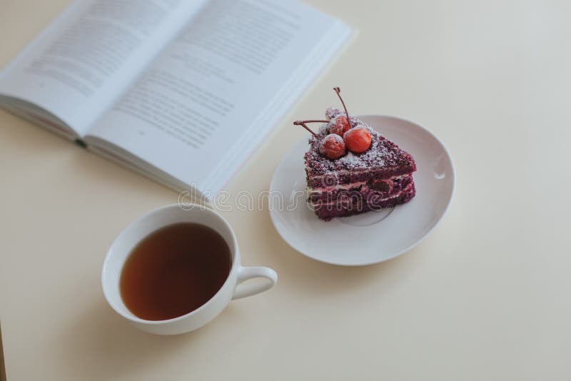 Cake on the Plate Next To Cup of Coffee and Open Book on Wooden Table ...