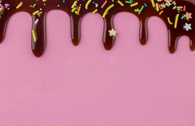 Cake Topping Coloured Sprinkles with Chocolate Flowing Down on Pink ...