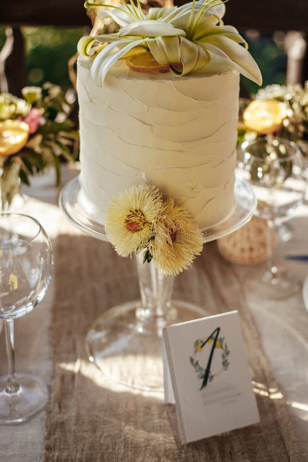 Cake with White Cream, Decorated with Lilies, Asters and Lemon Slices ...