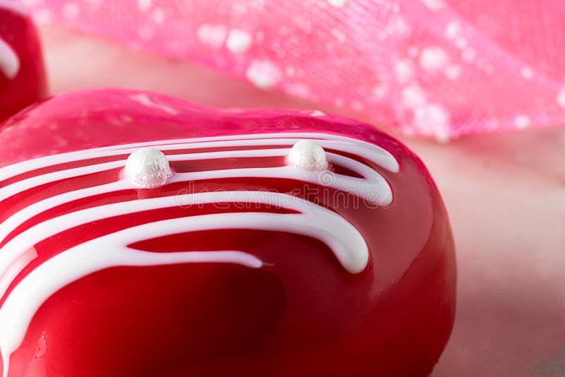 Cakes in the Form of Glazed Red Hearts on a Pink Marble Table, Close-up ...