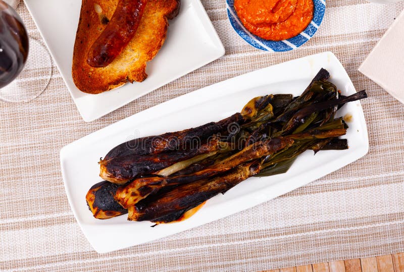 Calcot Served on Table with Romesco Sauce and Botifarra Stock Photo ...
