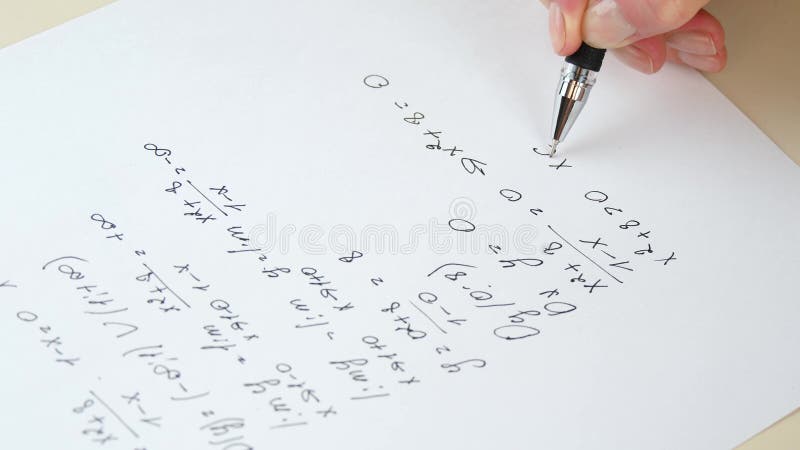 Calculation of Mathematical Formulas. a Close-up Hand Writes an ...