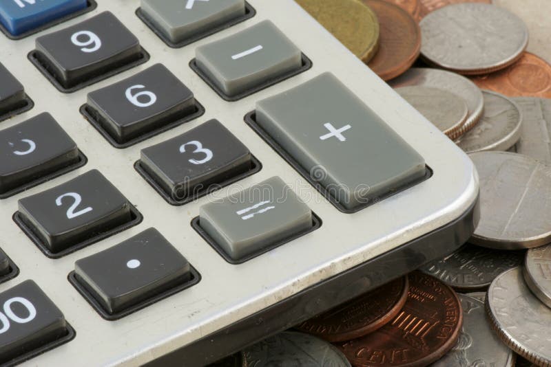 Calculator on coins stock image. Image of economy, isolated - 19732799