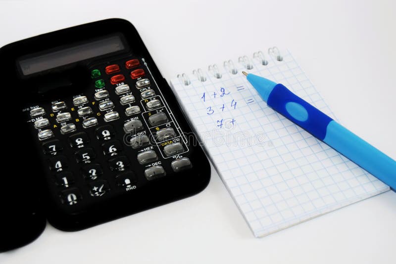 Calculator for Counting Examples in a Notebook with a Blue Pen on a ...