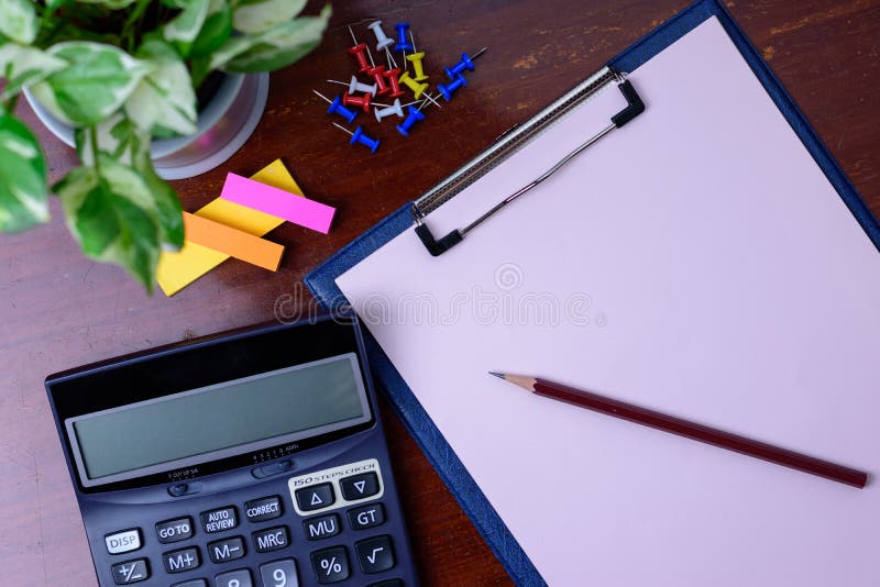 Calculator, File, Pencil and Office Supplies. Placed beside a Tree on a ...