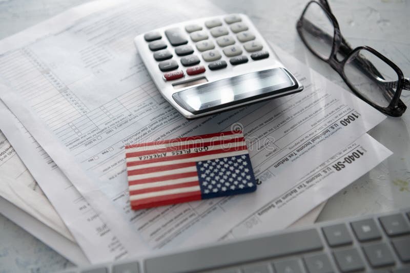 Calculator and Glasses on a Financial Statement. Documnts and Tax Forms ...