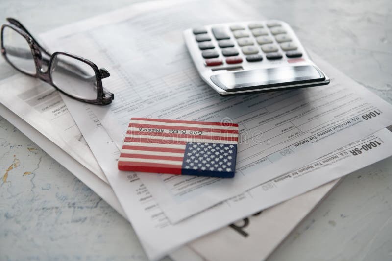 Calculator and Glasses on a Financial Statement. Dacumnts and Tax Forms ...