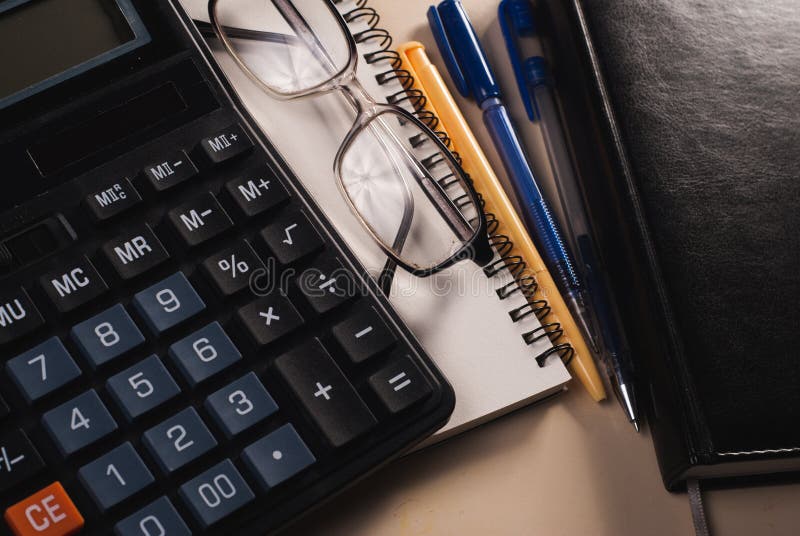 Calculator, Glasses and a Notepad on the Table, Leather Notebook, Stock ...