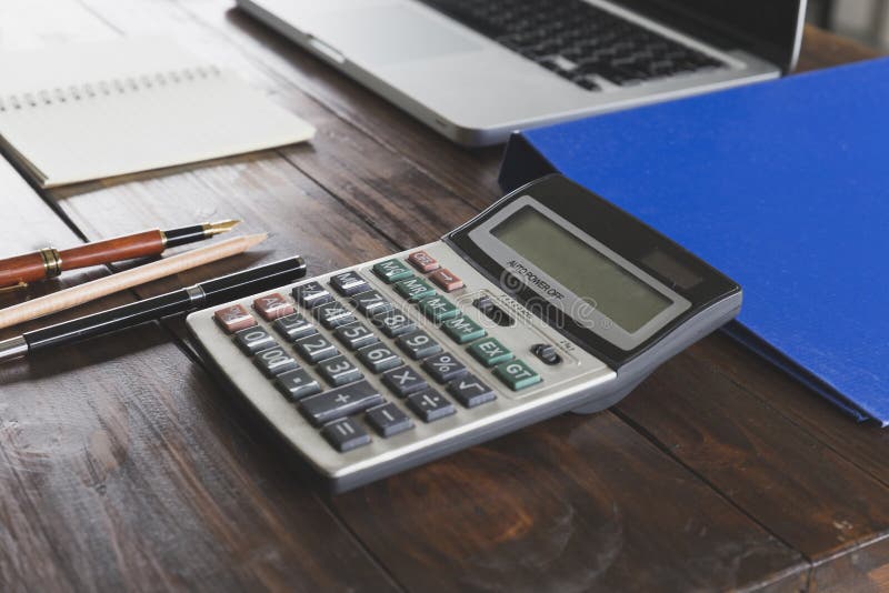 Calculator, Laptop Computer, Pen and Notebook on Office Desk Stock ...
