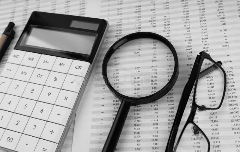 Calculator, Magnifying Glass, Pen, Eye Glasses on Financial Statement ... Calculator, Magnifying Glass, Pen, Eye Glasses on Financial Statement ...