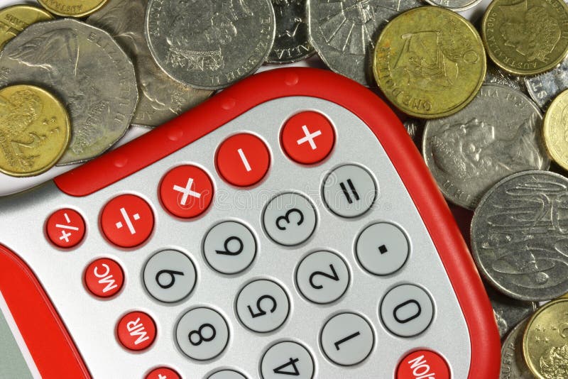 Red Calculator Sitting On Top Of Coins Of Money Stock Image - Image of ...