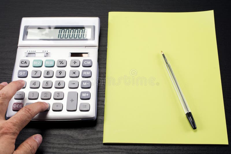 Calculator and notebook stock photo. Image of reckoning - 66540754