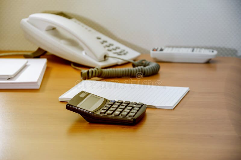 Calculator, Notepad and Office Phone on the Table. Side View . Close-up ...