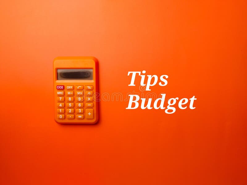 Calculator on a Orange Background with Text Tips Budget Stock Image ...