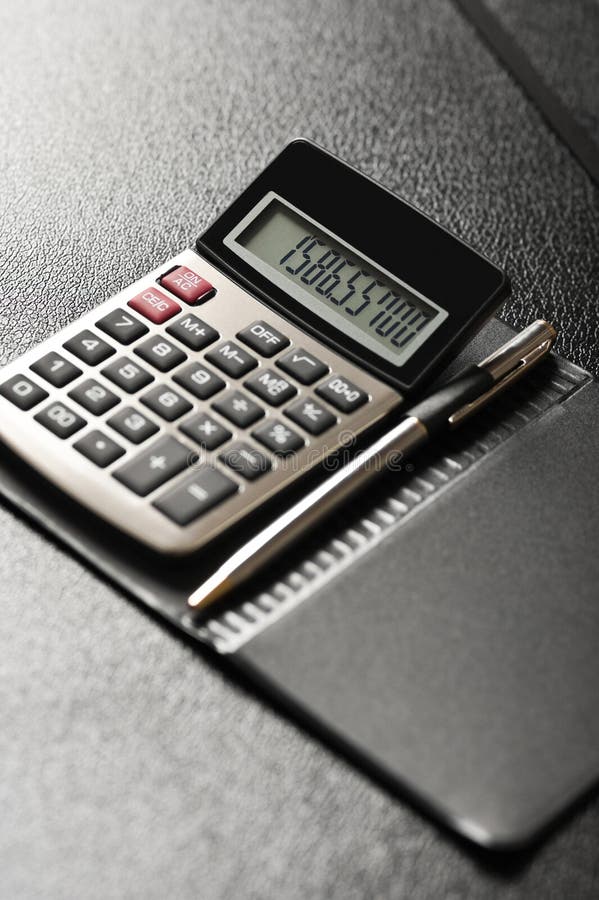 Calculator with a pen stock image. Image of business - 10776643