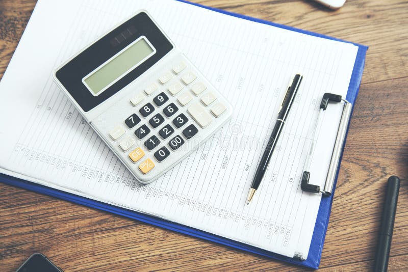 Calculator and Pen on Document Stock Photo - Image of table, calculator ...