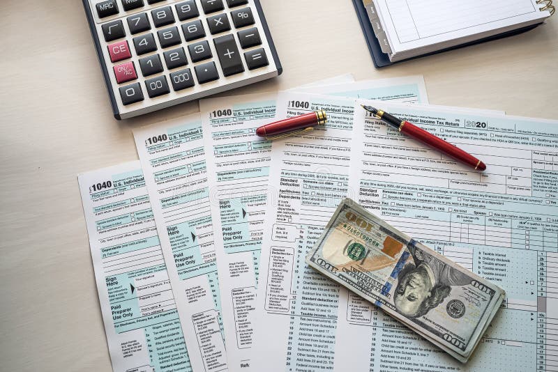 Calculator Red Pen Tax Forms 1040 Spread Out on a Spacious Table ...