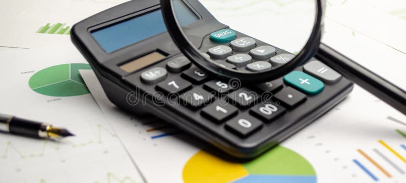Calculator Seen through Magnifying Glass on Charts Stock Image - Image ...