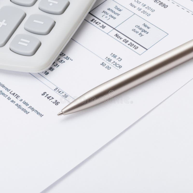 Calculator with Silver Pen and Utility Bill Under it - Close Up Shot ...