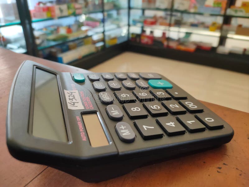 A Calculator on the Table at the Edge Stock Image - Image of table ...