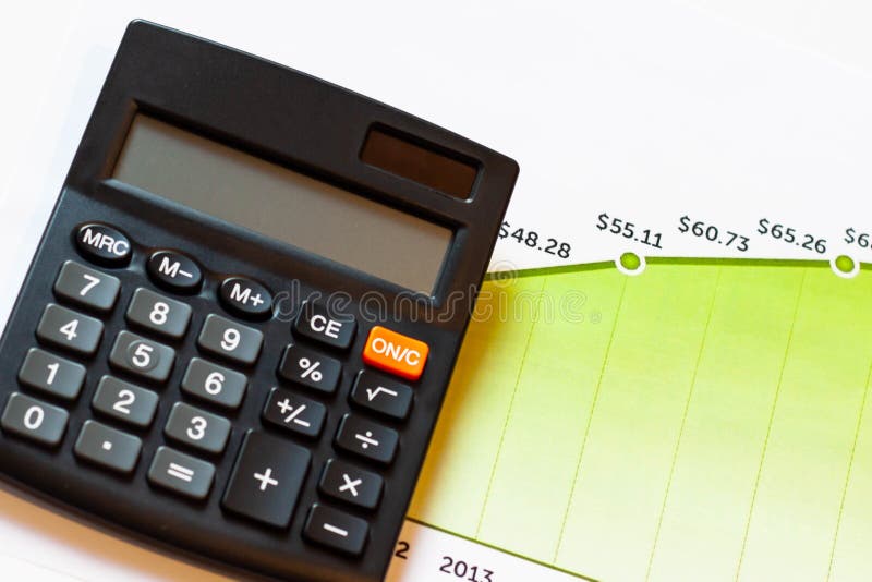 Calculator on the Table with Financial Papers. Green Diagram at Home ...