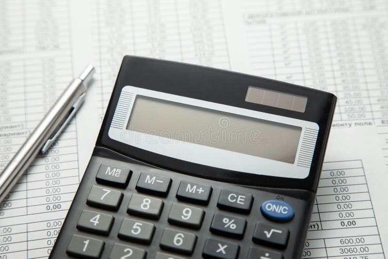 Calculator on the Table with Paper Tables and Pen Stock Photo - Image ...