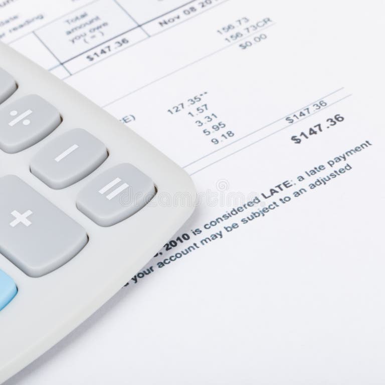 Calculator with Utility Bill Under it - Close Up Studio Shot Stock ...