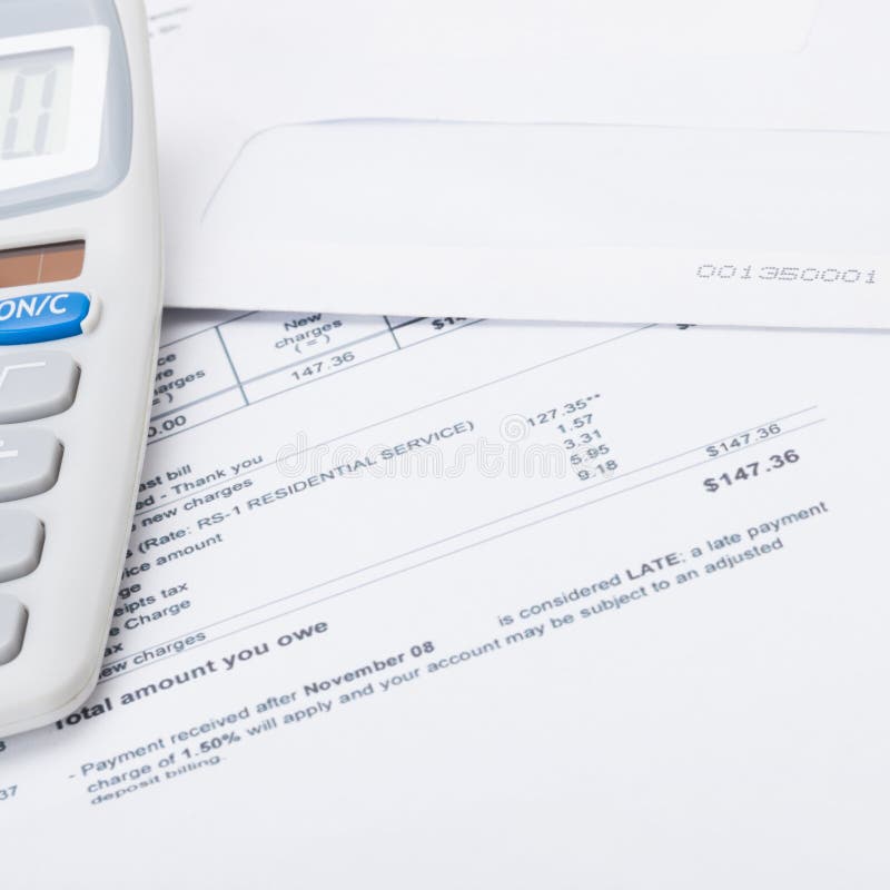 Calculator with Utility Bill Under it - Close Up Stock Image - Image of ...