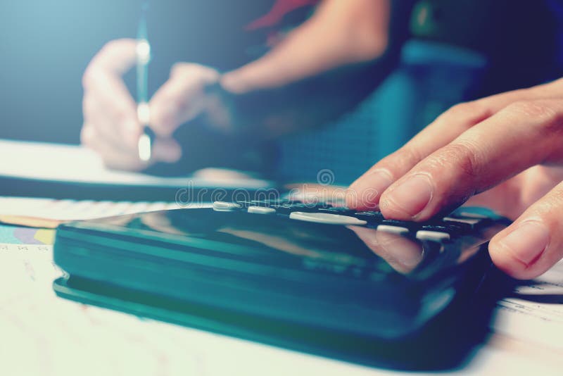 Calculator with Woman Hand Typing and Writing Make Note Stock Photo ...