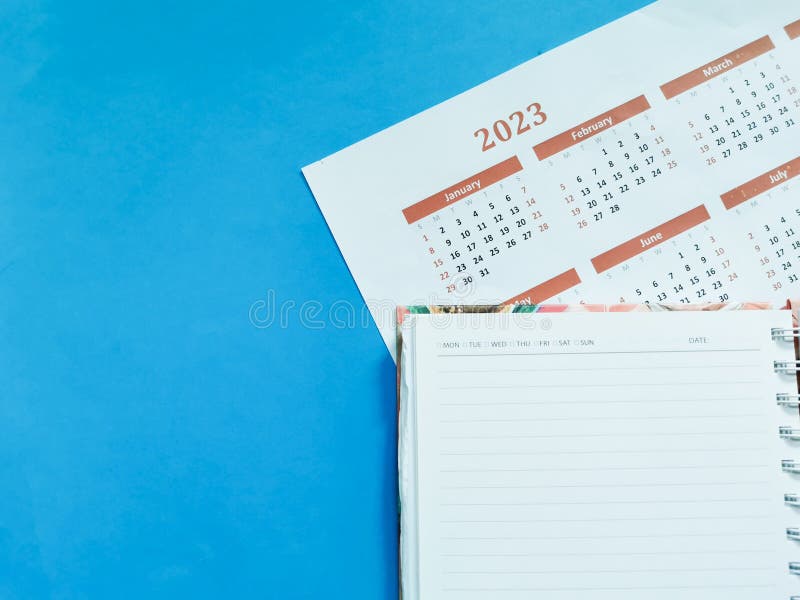 2023 Calendar with Black Note Book Against Blue Background. Stock Image ...