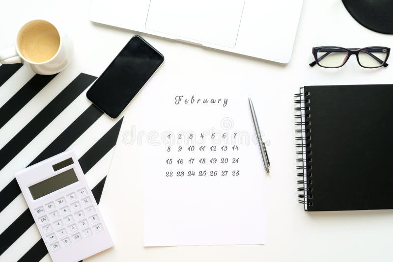 Calendar of February on White Desktop Flat Ley with a Cup of Coffee and ...