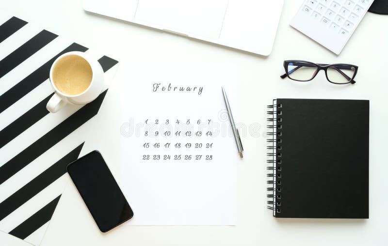 Calendar of February on White Desktop Flat Ley with a Cup of Coffee and ...