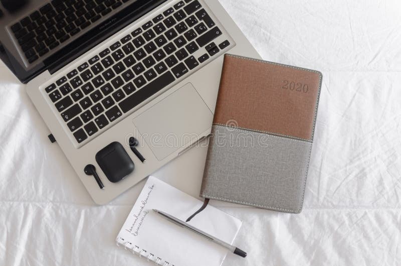 2020 Calendar Notebook Along with a Laptop, Black Wireless Earbuds and ...