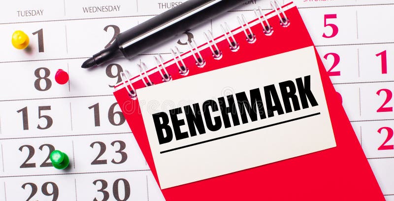 On the Calendar is a White Card with the Text BENCHMARK. Nearby is a ...