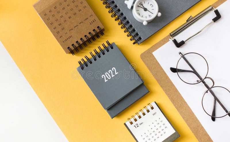Calendars 2022 , Note Pad and Glasses on Table Top View. New Year ...