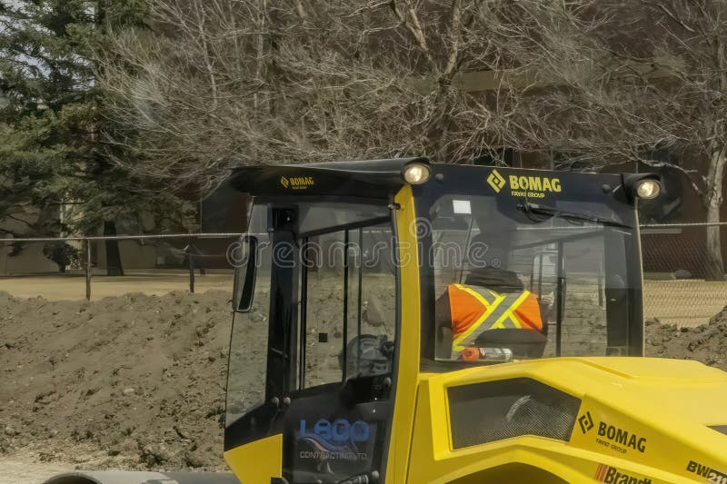 A Construction Worker Driving a BOMAG Single Drum Roller for Soil ...