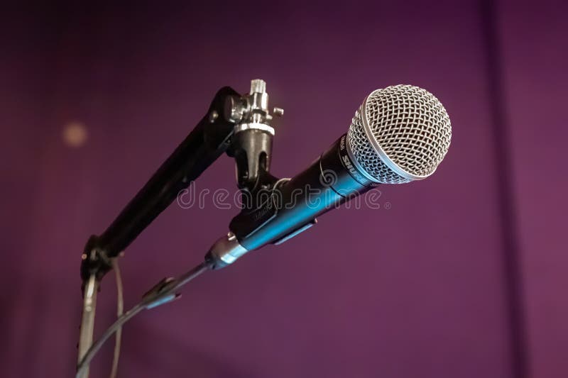 A Black Microphone Stand Holds a Shure SM58 Securely in a Recording ...